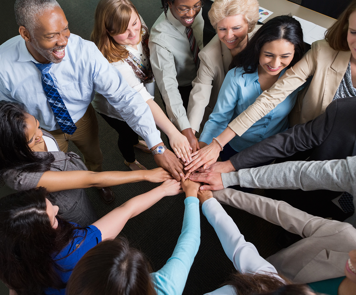 Diverse Team Of Professionals With Hands In Teamwork Huddle GMS